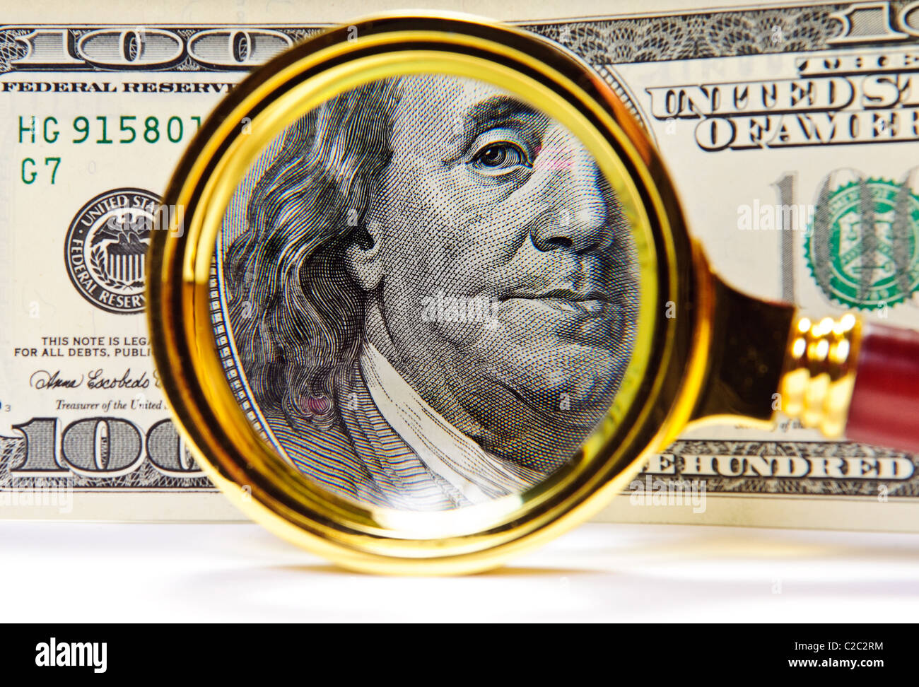 Dollar magnifying glass over money Stock Photo - Alamy