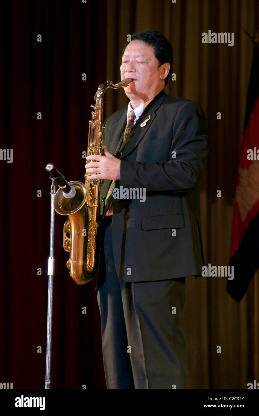 A disabled blind (without vision) Asian man wearing a suit and tie is ...
