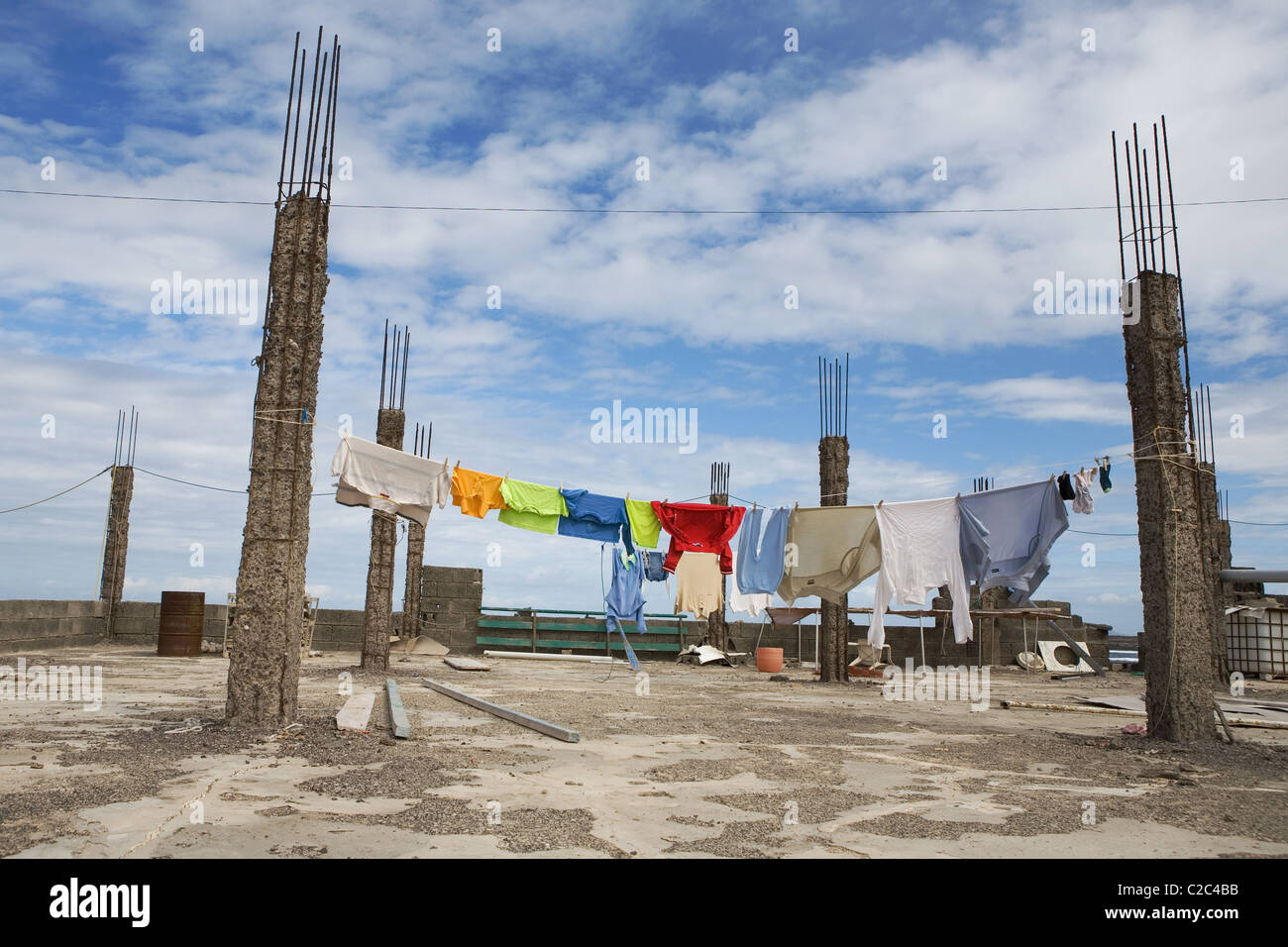 laundry hanging between concrete construction Stock Photo - Alamy