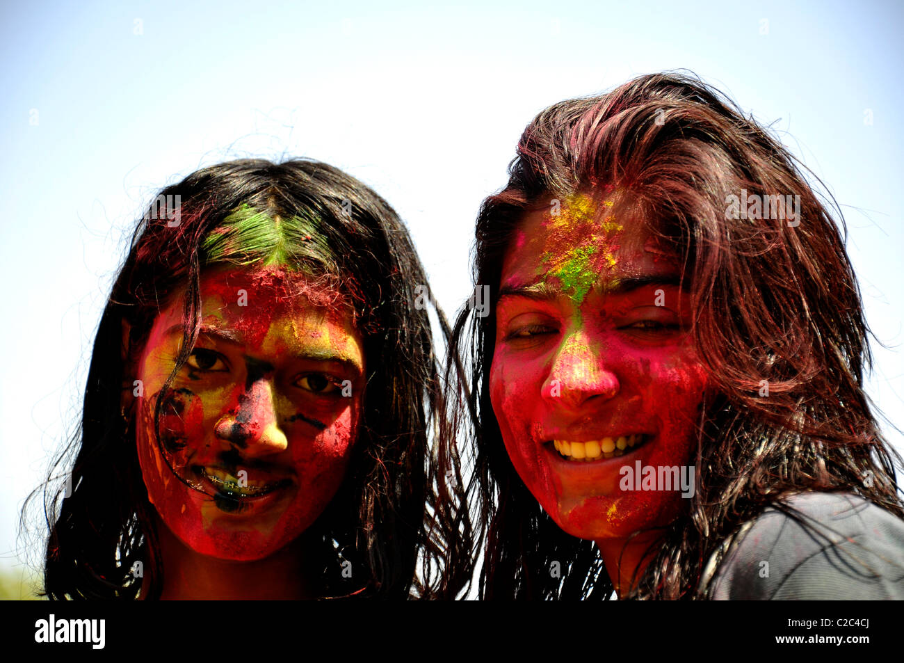 Two Indian girls playing holi Stock Photo - Alamy