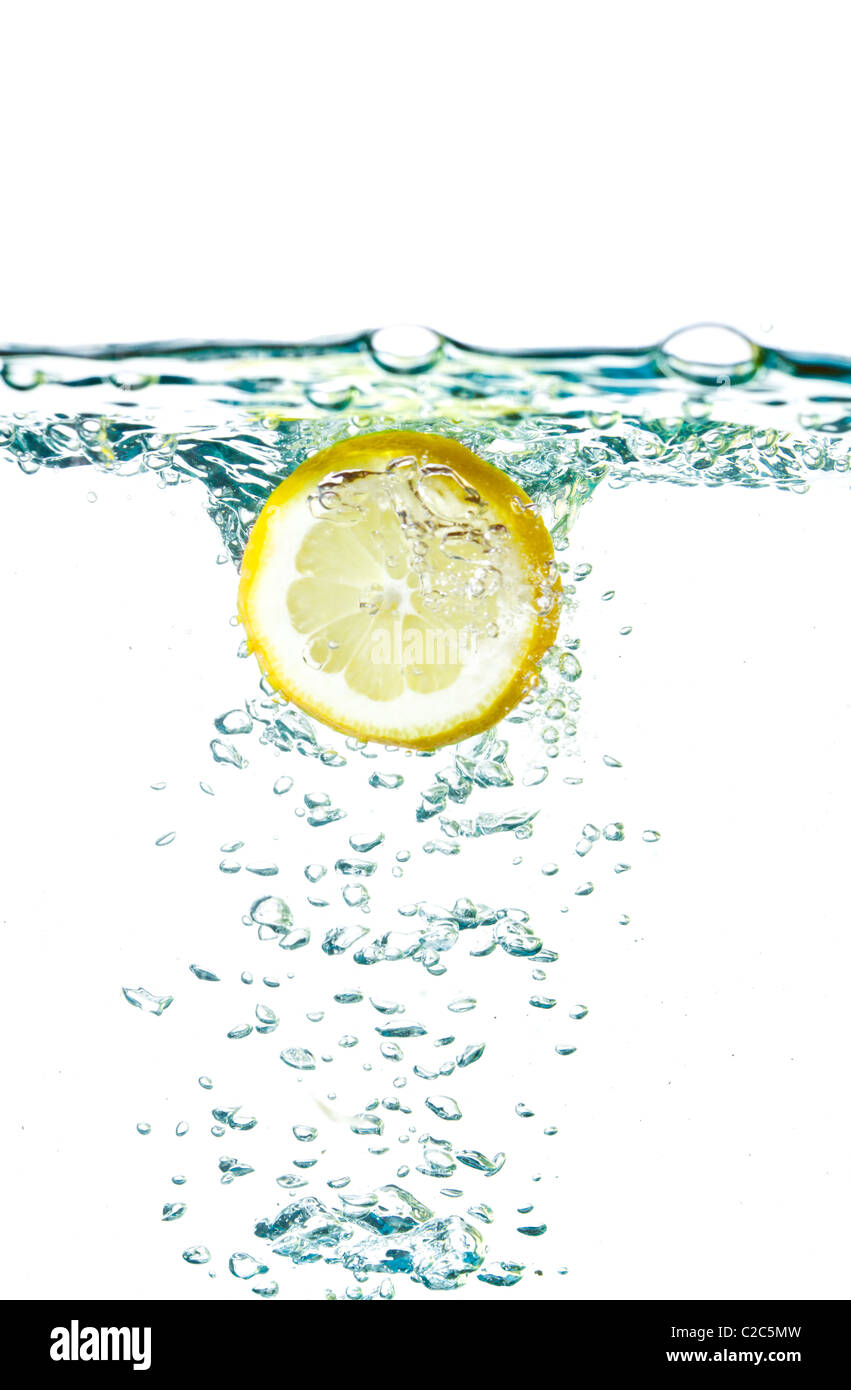 Fresh lemon splashing water isolated on white Stock Photo - Alamy