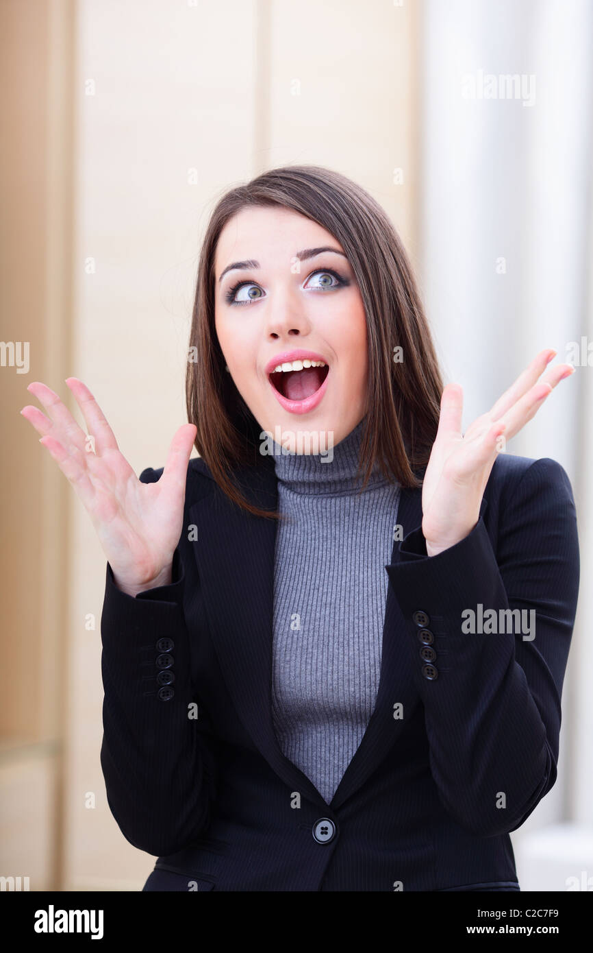 Very happy and surprised young beautiful businesswoman Stock Photo - Alamy