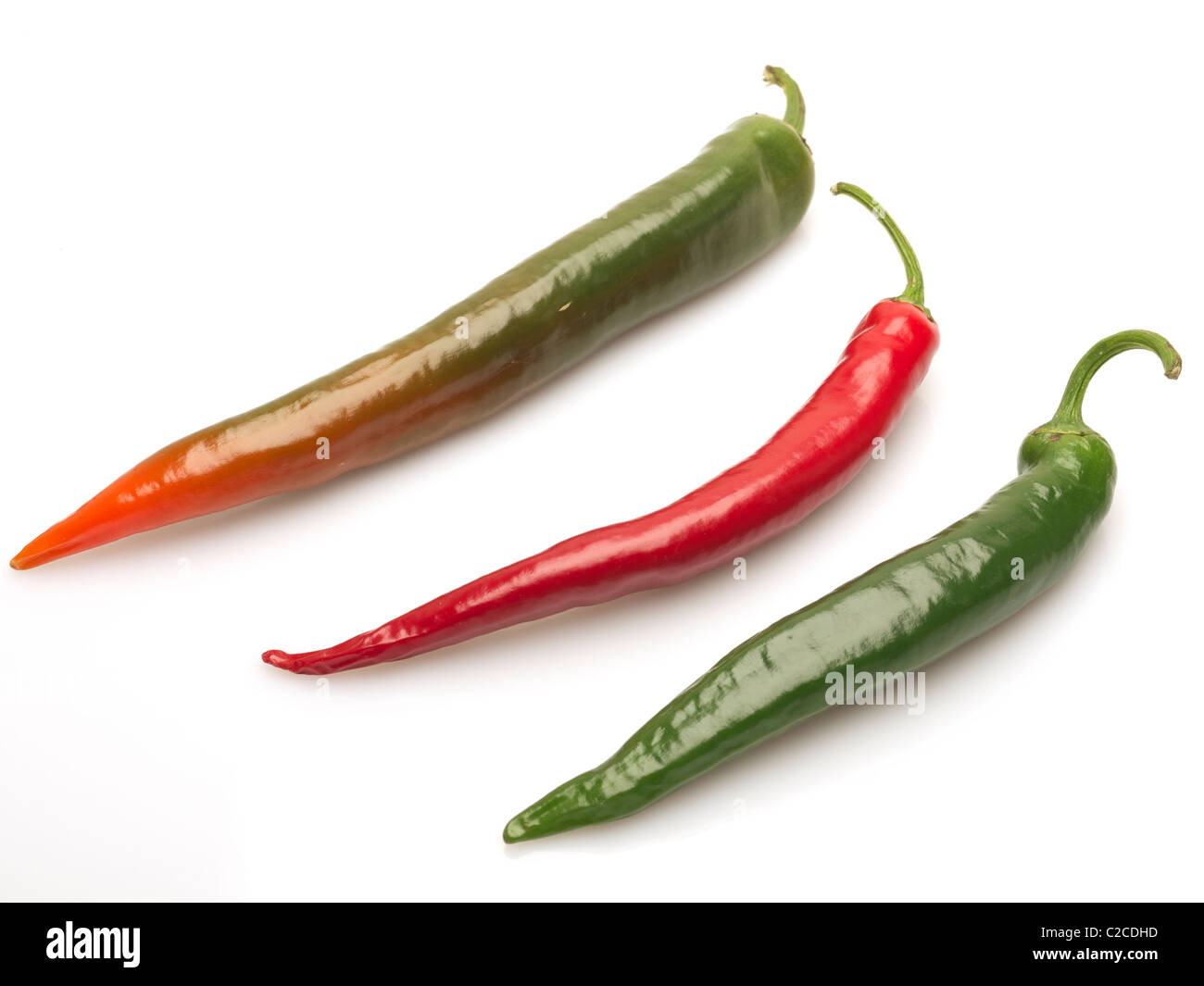 Three peppers in a line, green and red Stock Photo - Alamy