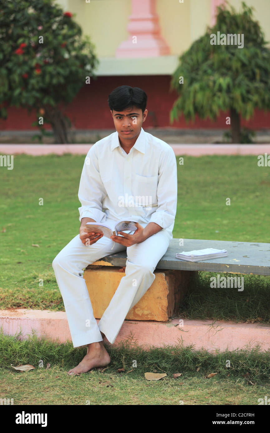 Young Indian student reading a book Andhra Pradesh South India Stock ...