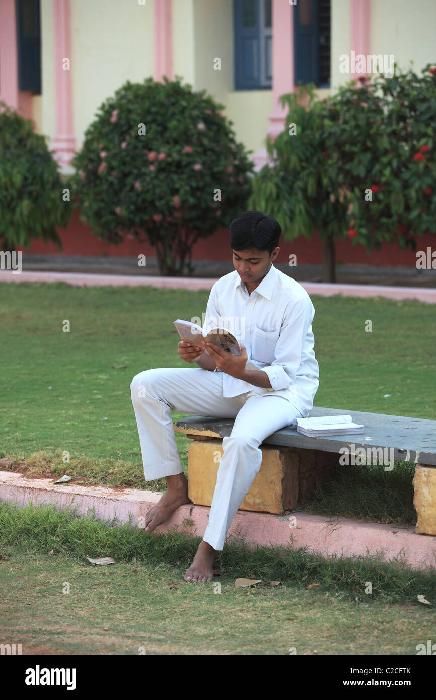 Young Indian student reading a book Andhra Pradesh South India Stock ...