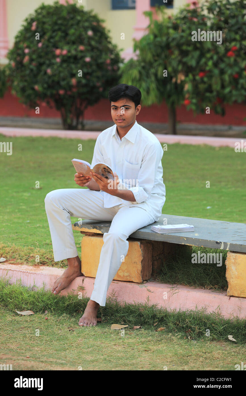 Young Indian student reading a book Andhra Pradesh South India Stock ...