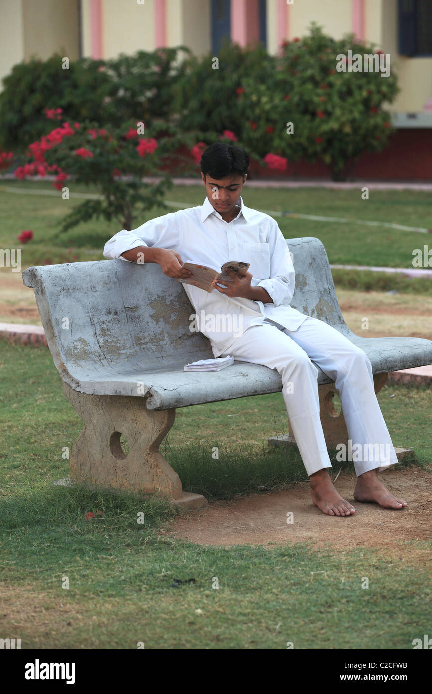 Young Indian student reading a book Andhra Pradesh South India Stock ...