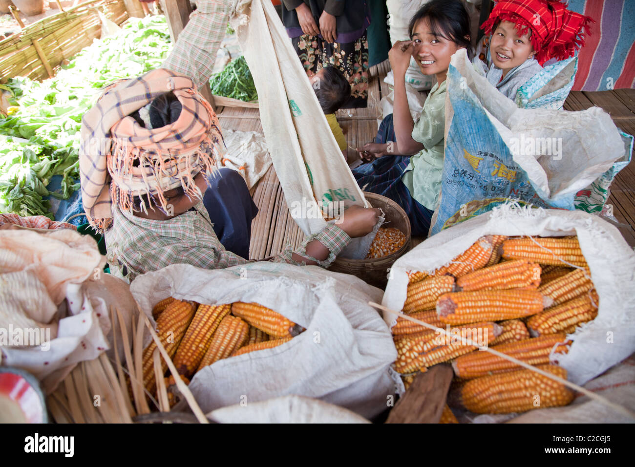Pa-O tribal woman and kids in native costume are sitting around corn ...