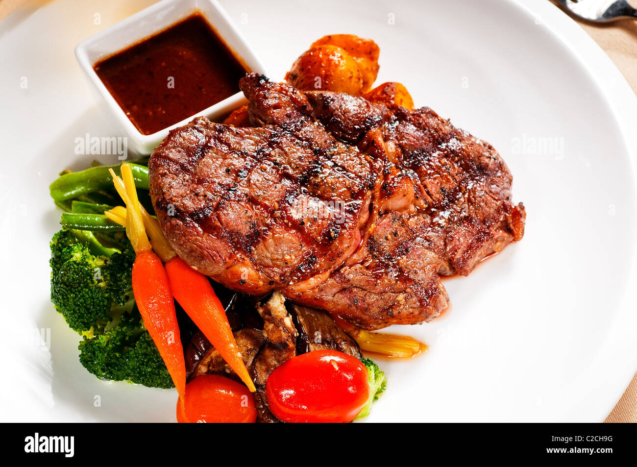 fresh grilled ribeye steak with broccoli,carrot and cherry tomatoes on ...