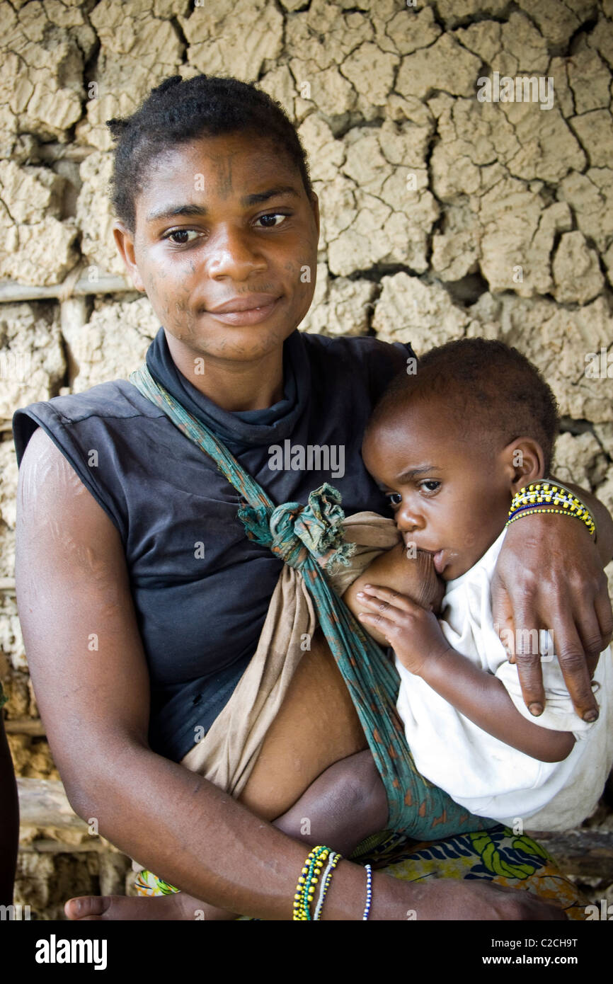 A pygmy breastfeeding her baby in a refugee camp ,Betou ,Ubangi River ...