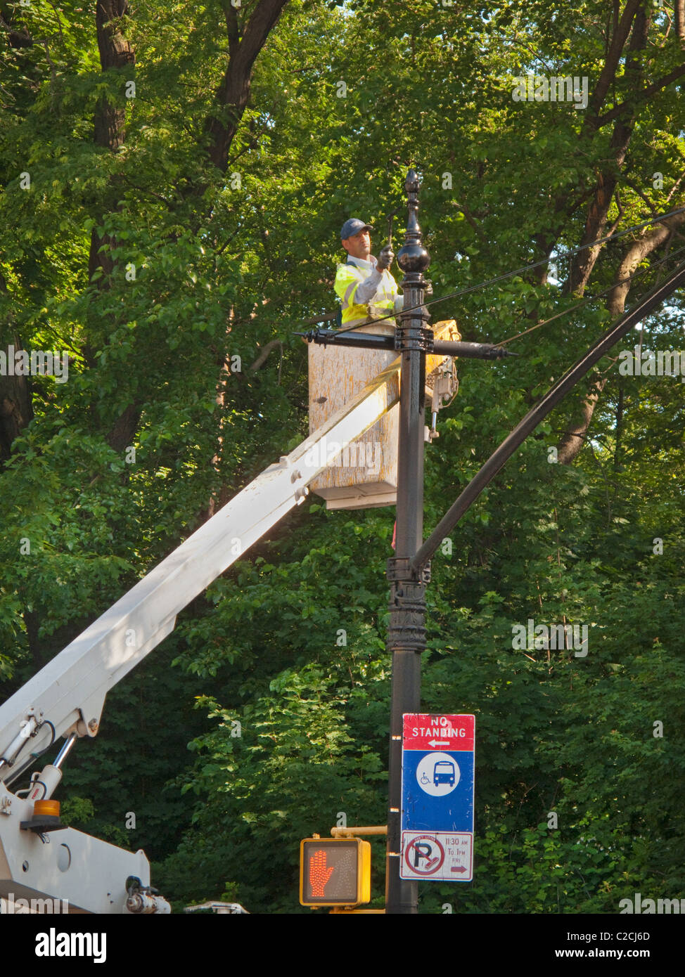 worker painting street light post Stock Photo - Alamy