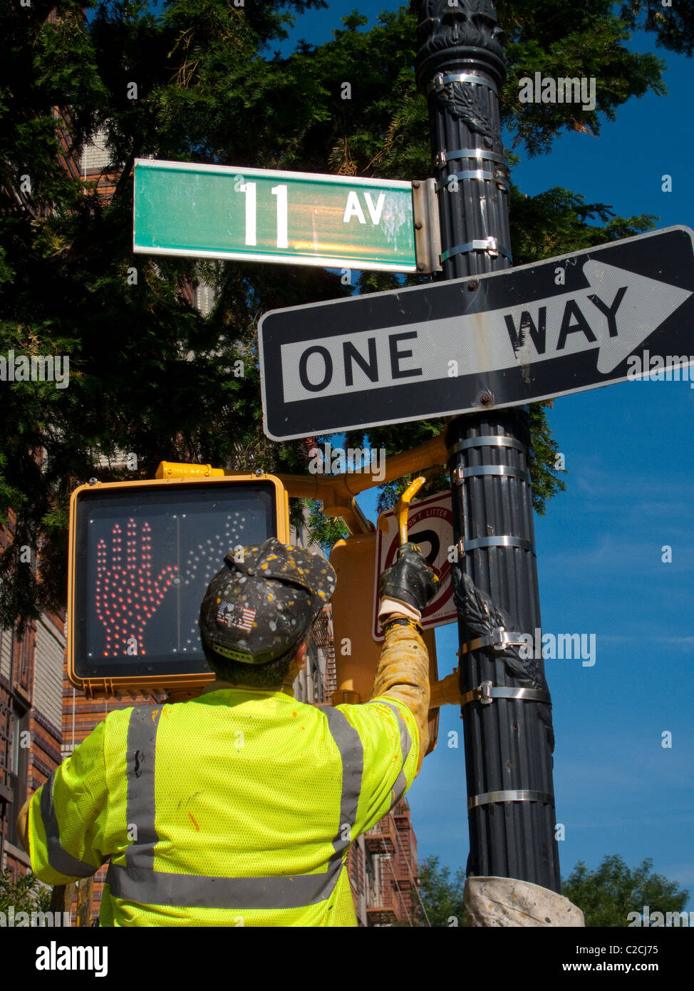 worker painting street light post Stock Photo - Alamy