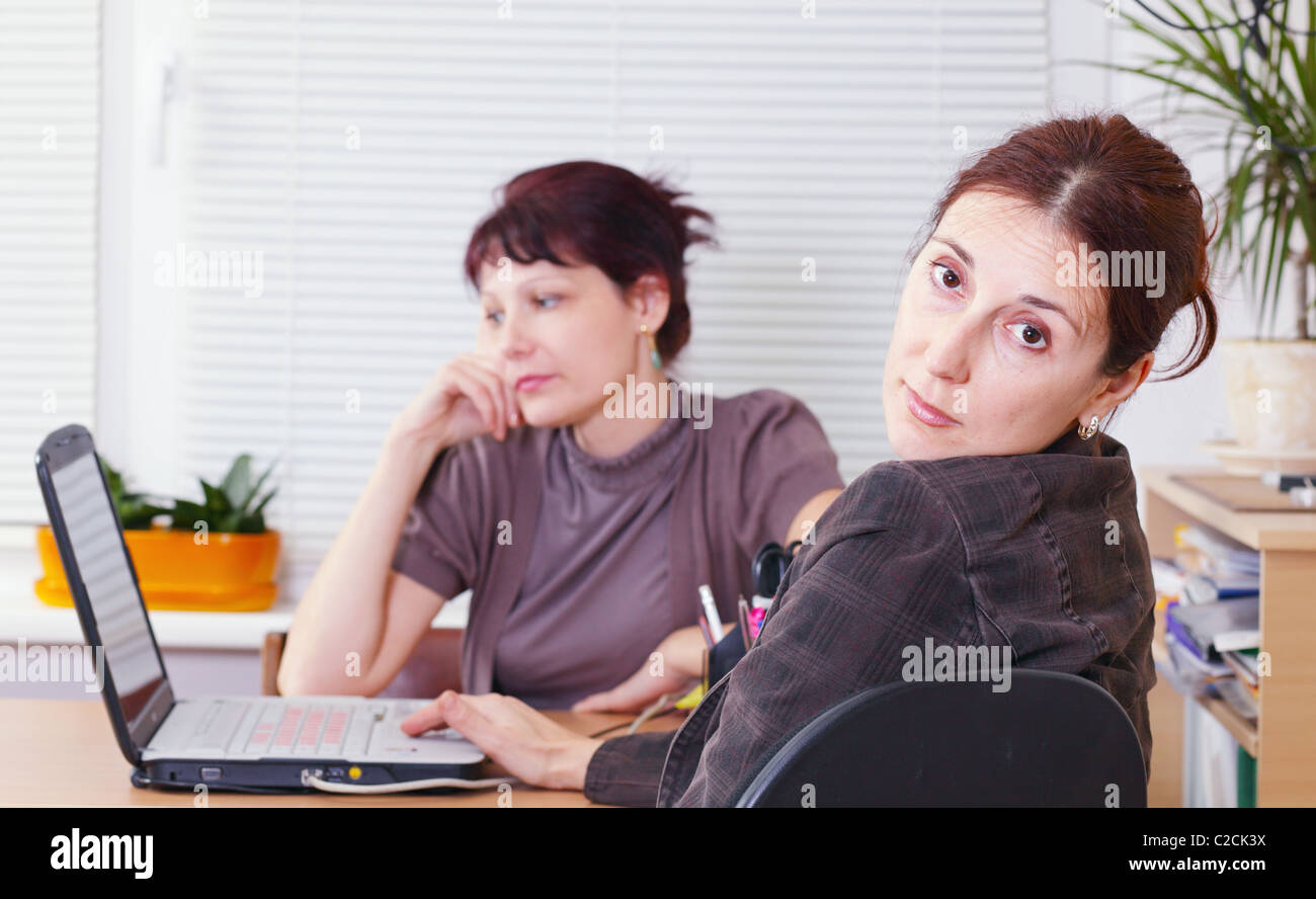 two teachers with laptop in classroom Stock Photo - Alamy