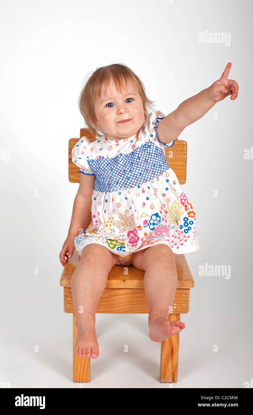 Baby girl pointing up Stock Photo - Alamy