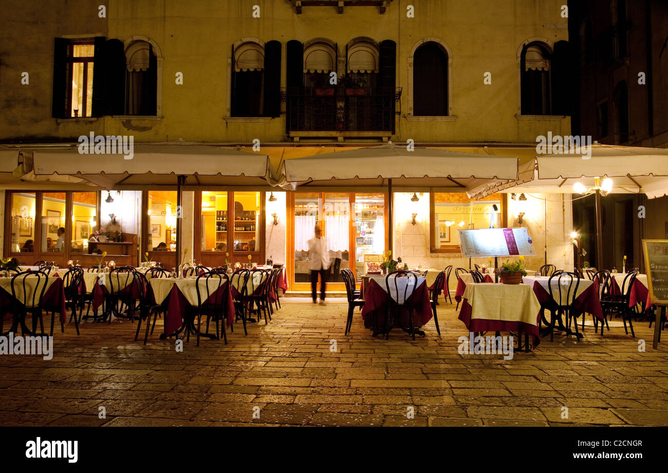 A waiter in an empty restaurant at night, Venice Italy Stock Photo - Alamy