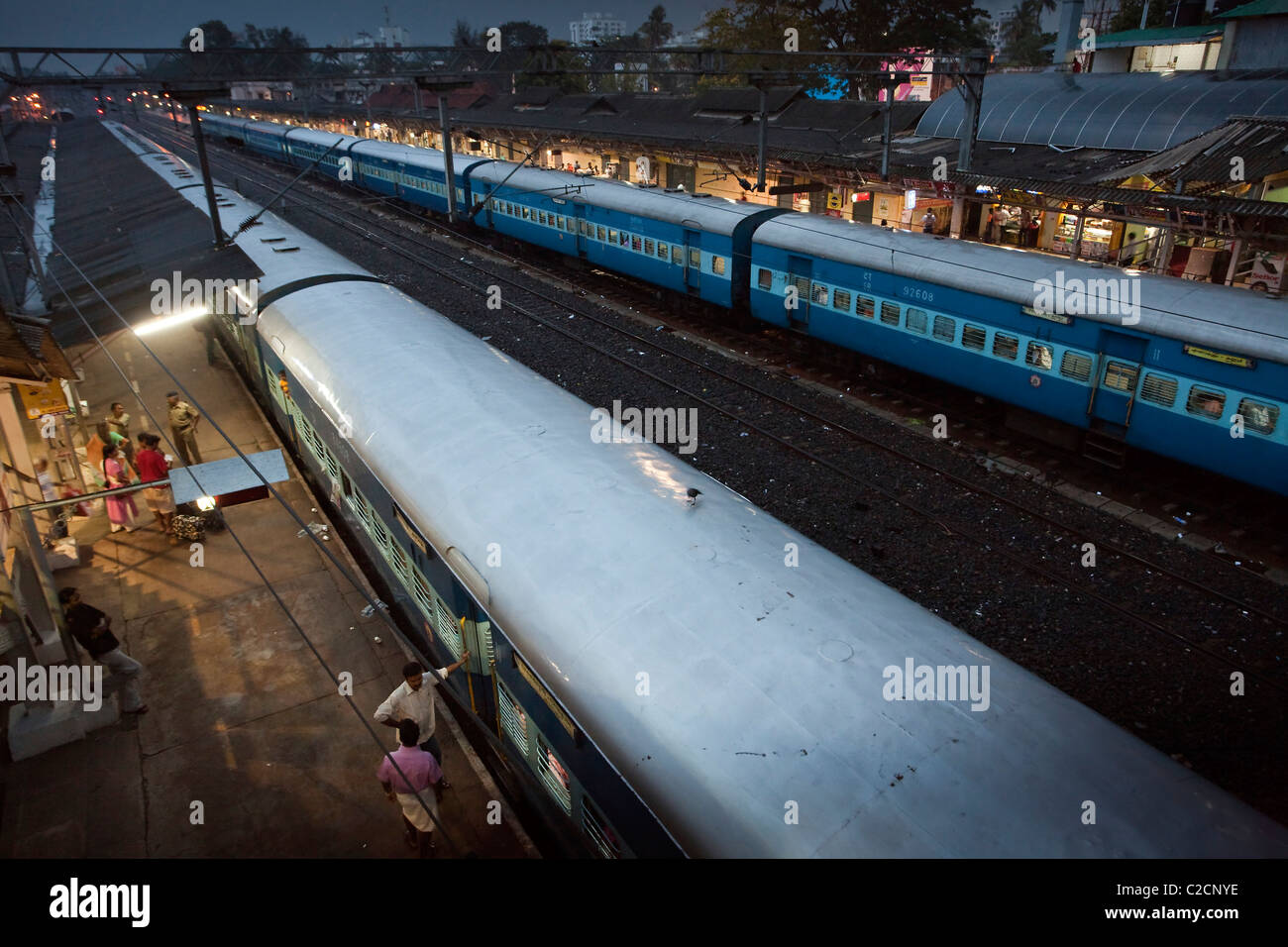 Trains pulling into a platform in a station late in the evening. South ...