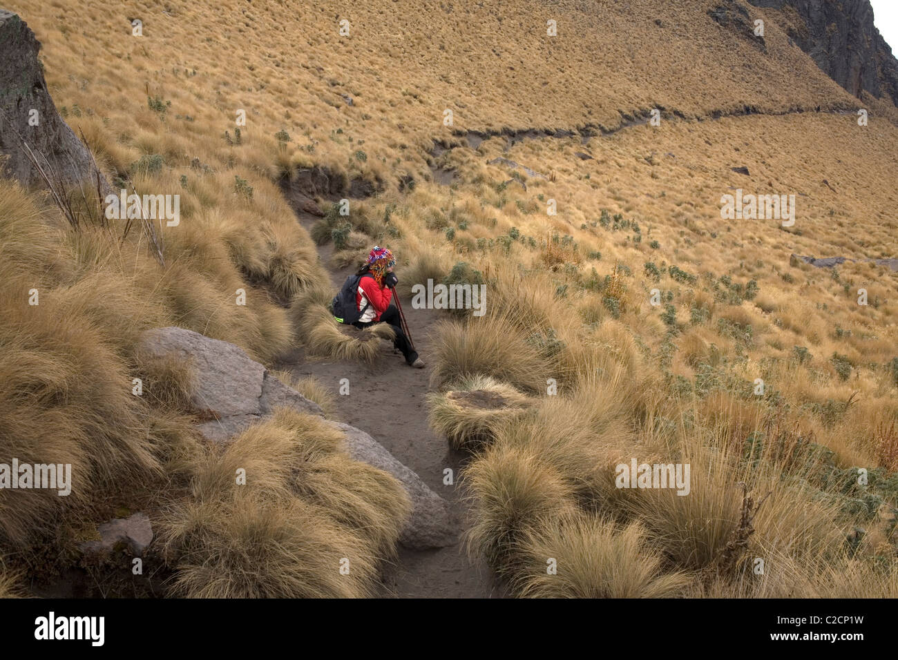 A woman sits during a trecking trip to the Volcano "Ixta" in the ...