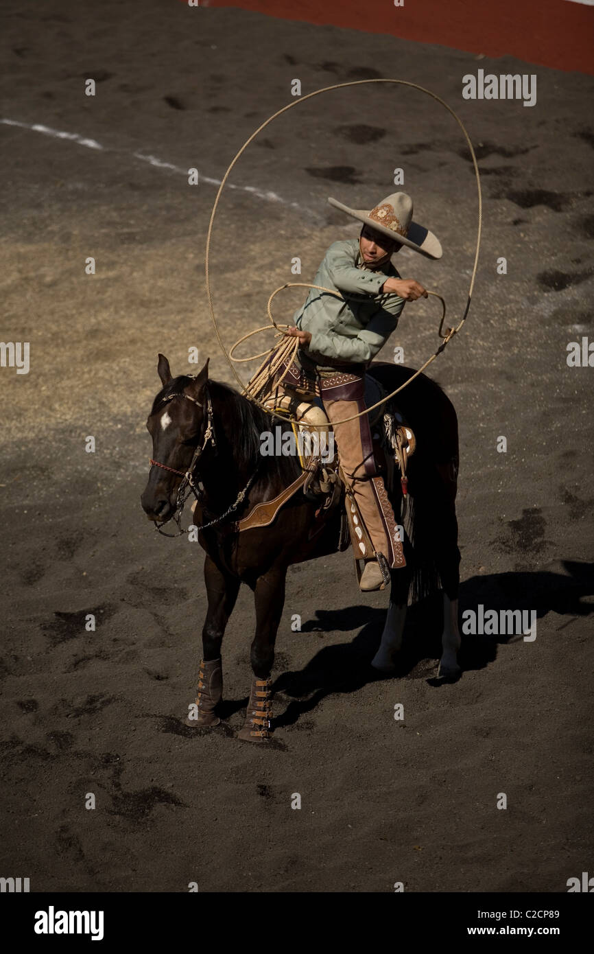 A Mexican Charro uses his lasso during a charreria exhibition in Mexico ...