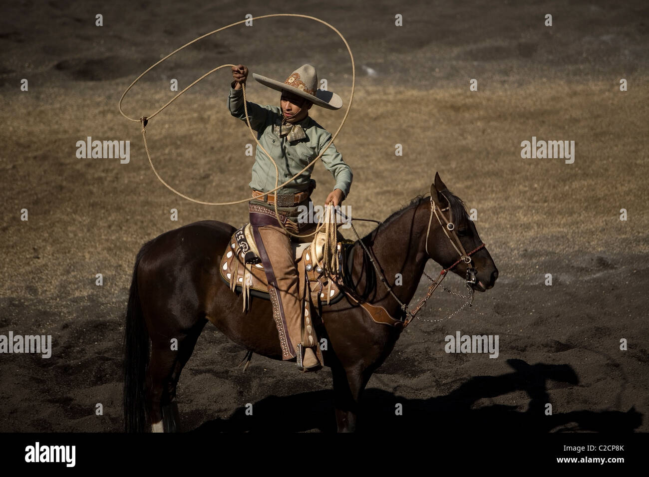A Mexican Charro uses his lasso during a charreria exhibition in Mexico ...