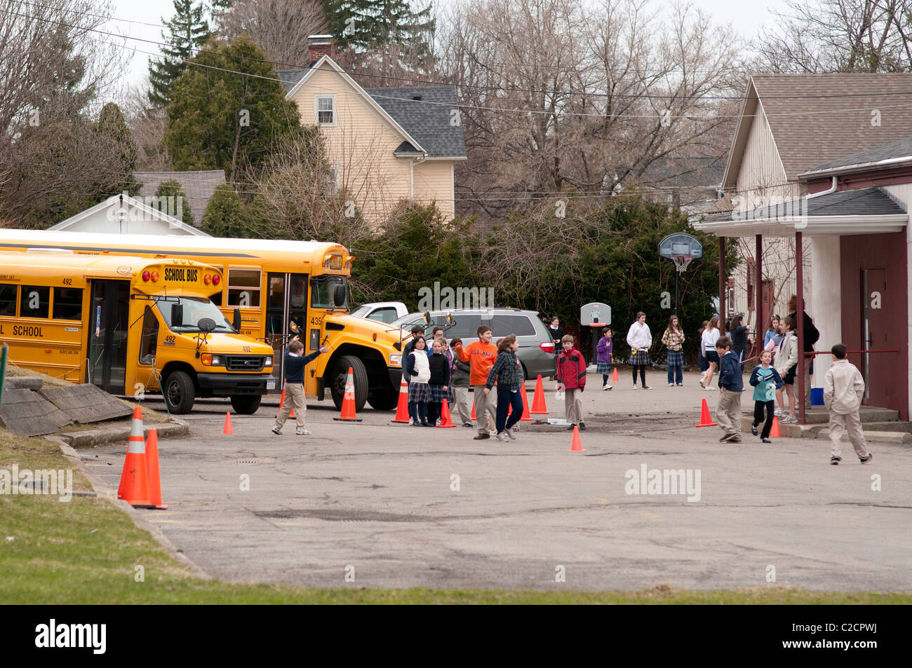 Students waiting to load on school bus Stock Photo - Alamy
