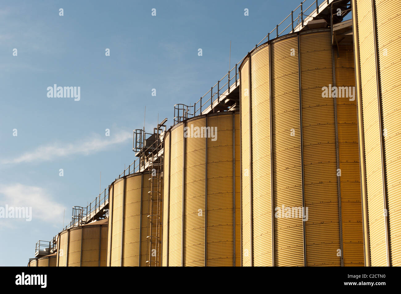 gas tanks in sunshine with blue sky Stock Photo - Alamy