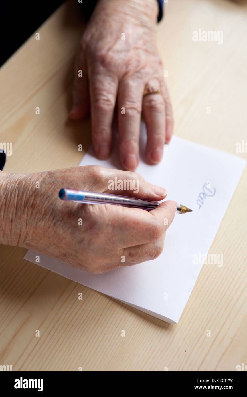 An old pair of hands writing a letter Stock Photo - Alamy