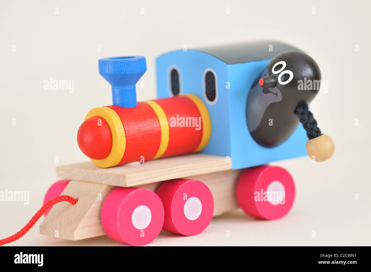 Wooden toy locomotive (machine, train, engine) with a mole poking out ...