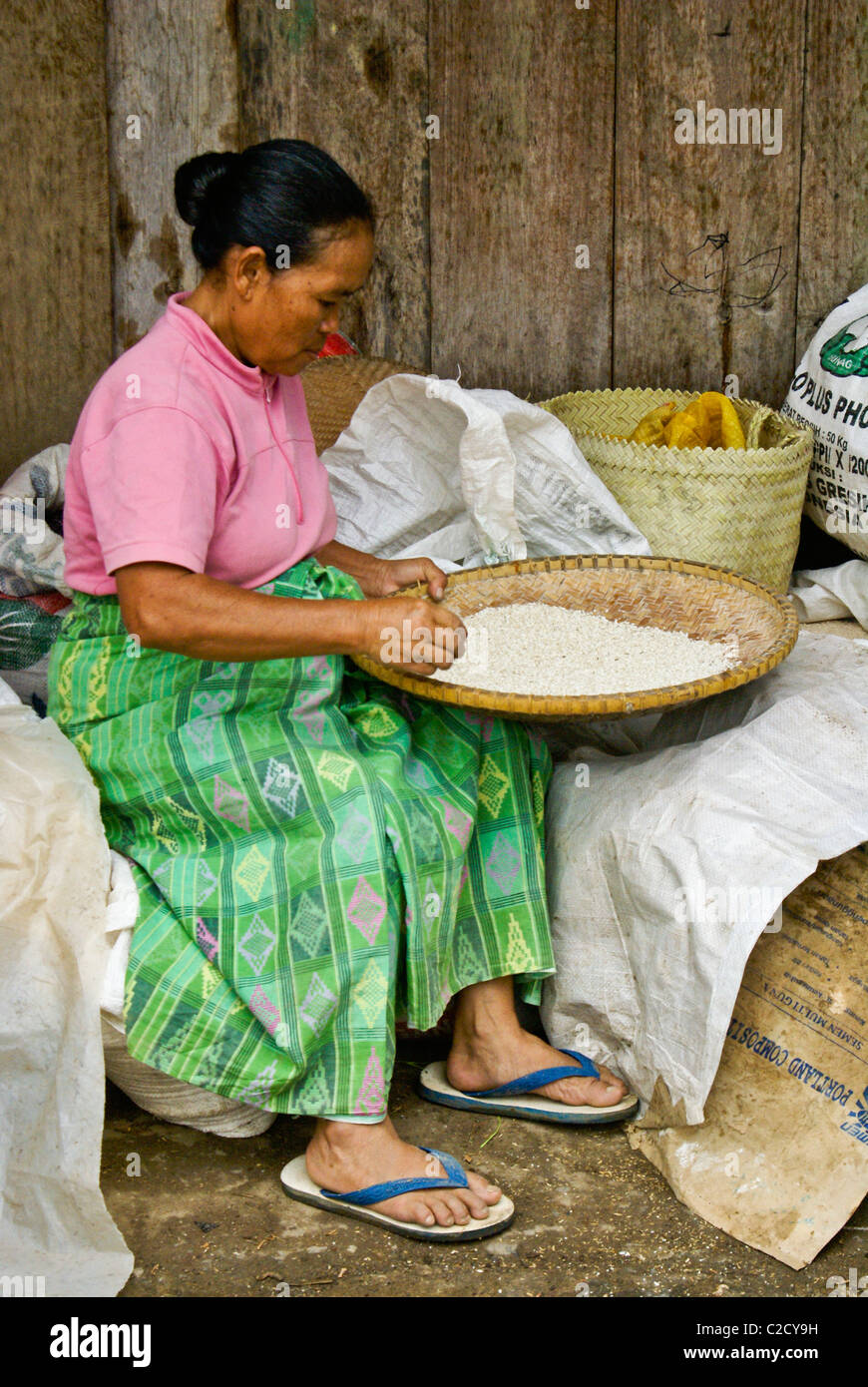 Woman cleaning rice at market, Tana Toraja, South Sulawesi, Indonesia ...