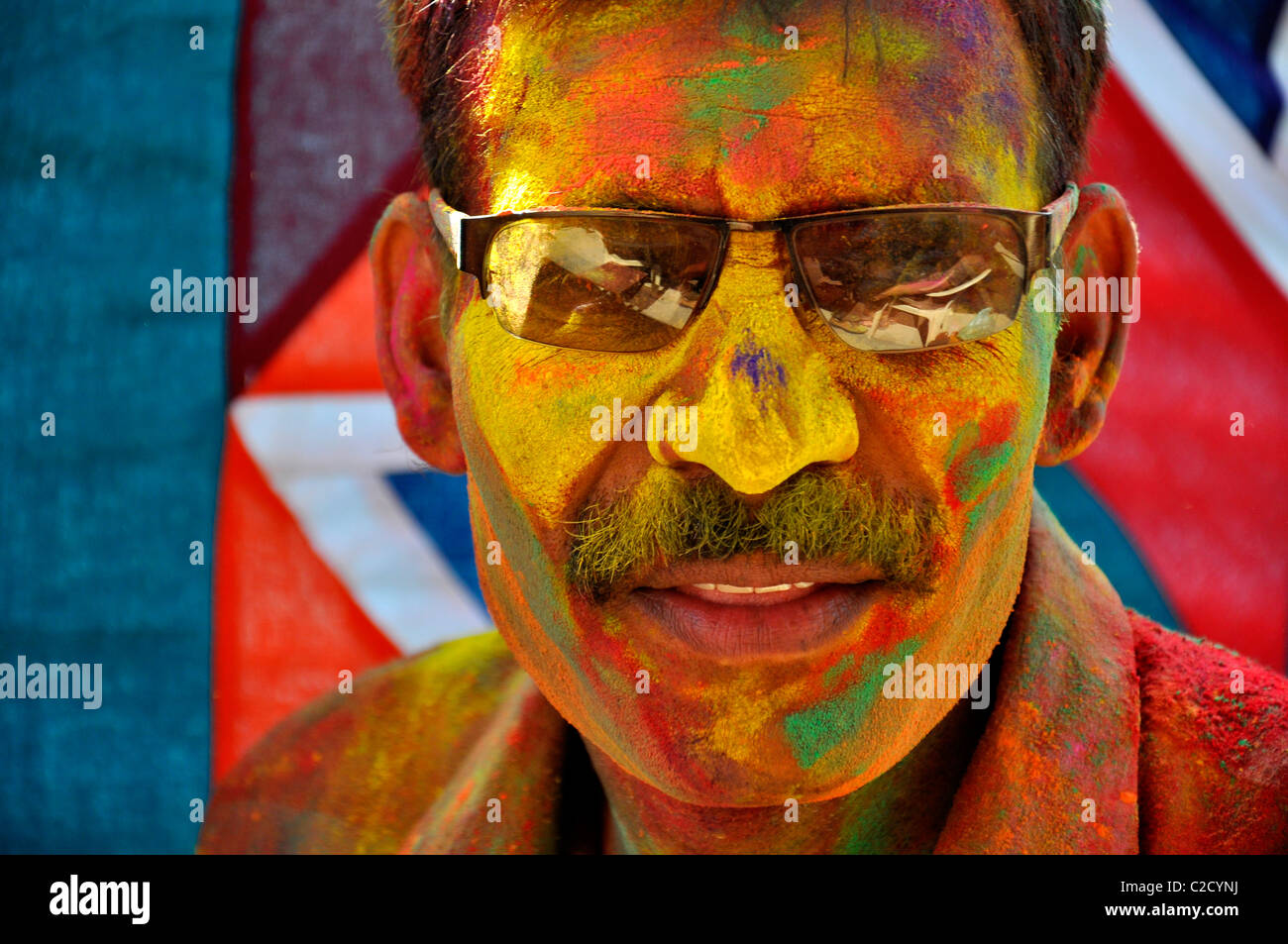An indian with coloured face on Holi festival Stock Photo - Alamy