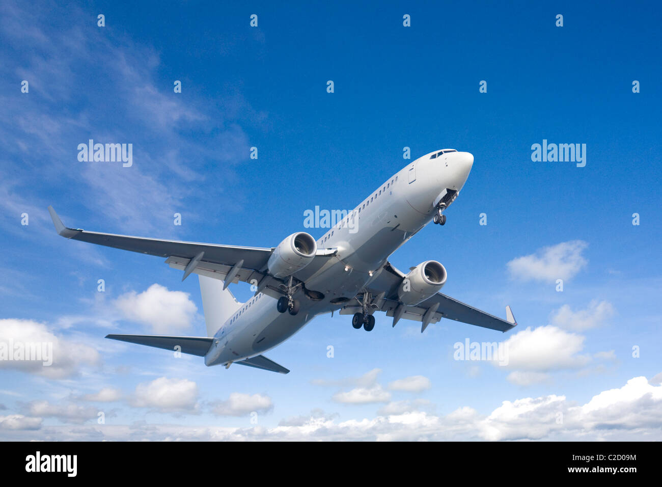 An airplane flying in the blue sky Stock Photo - Alamy