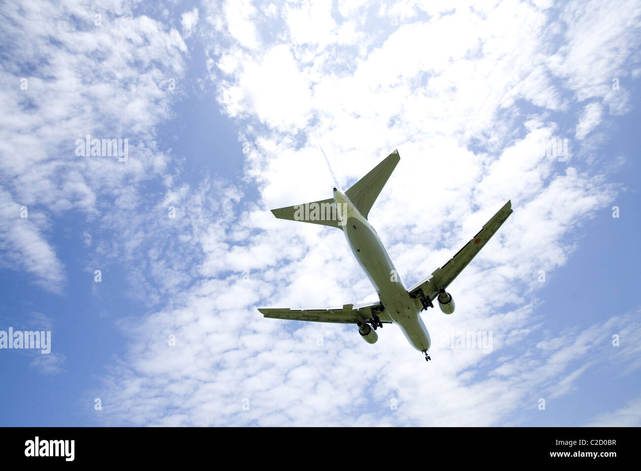 An airplane flying in the blue sky Stock Photo - Alamy