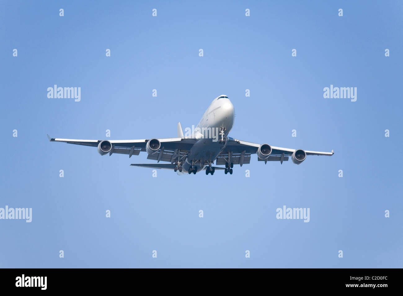 An airplane flying in the blue sky Stock Photo - Alamy