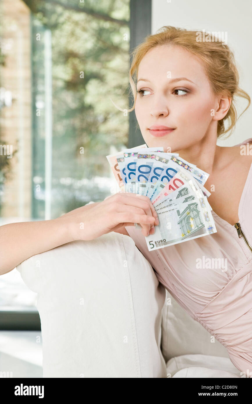 Woman holding money Stock Photo - Alamy