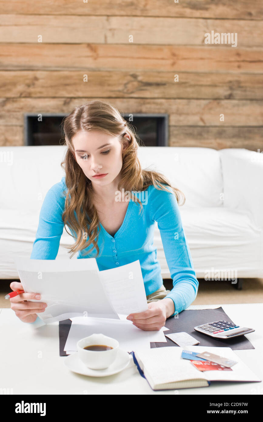 Woman reading documents at home Stock Photo - Alamy