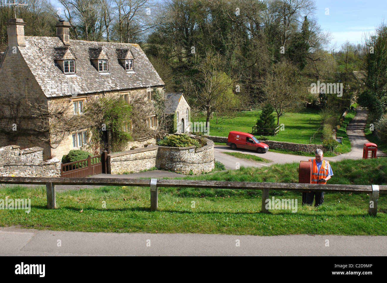 Postman emptying mail box in Duntisbourne Abbots village ...