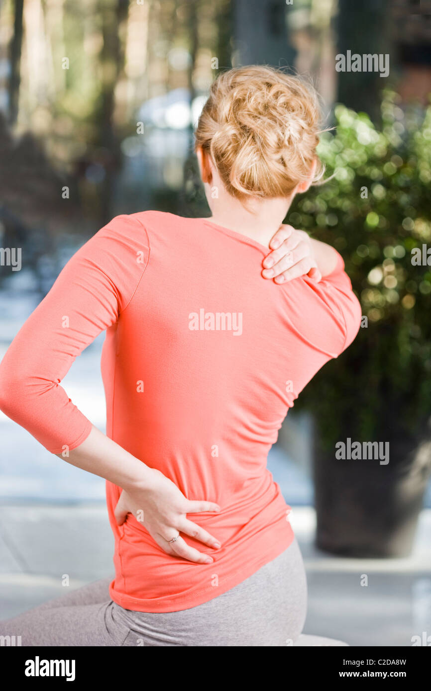 Woman with back pain Stock Photo - Alamy