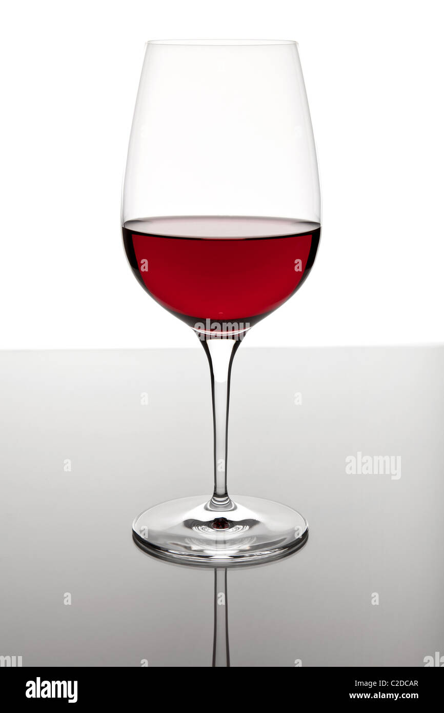 Glass of red wine on a bright background and with soft reflection Stock ...