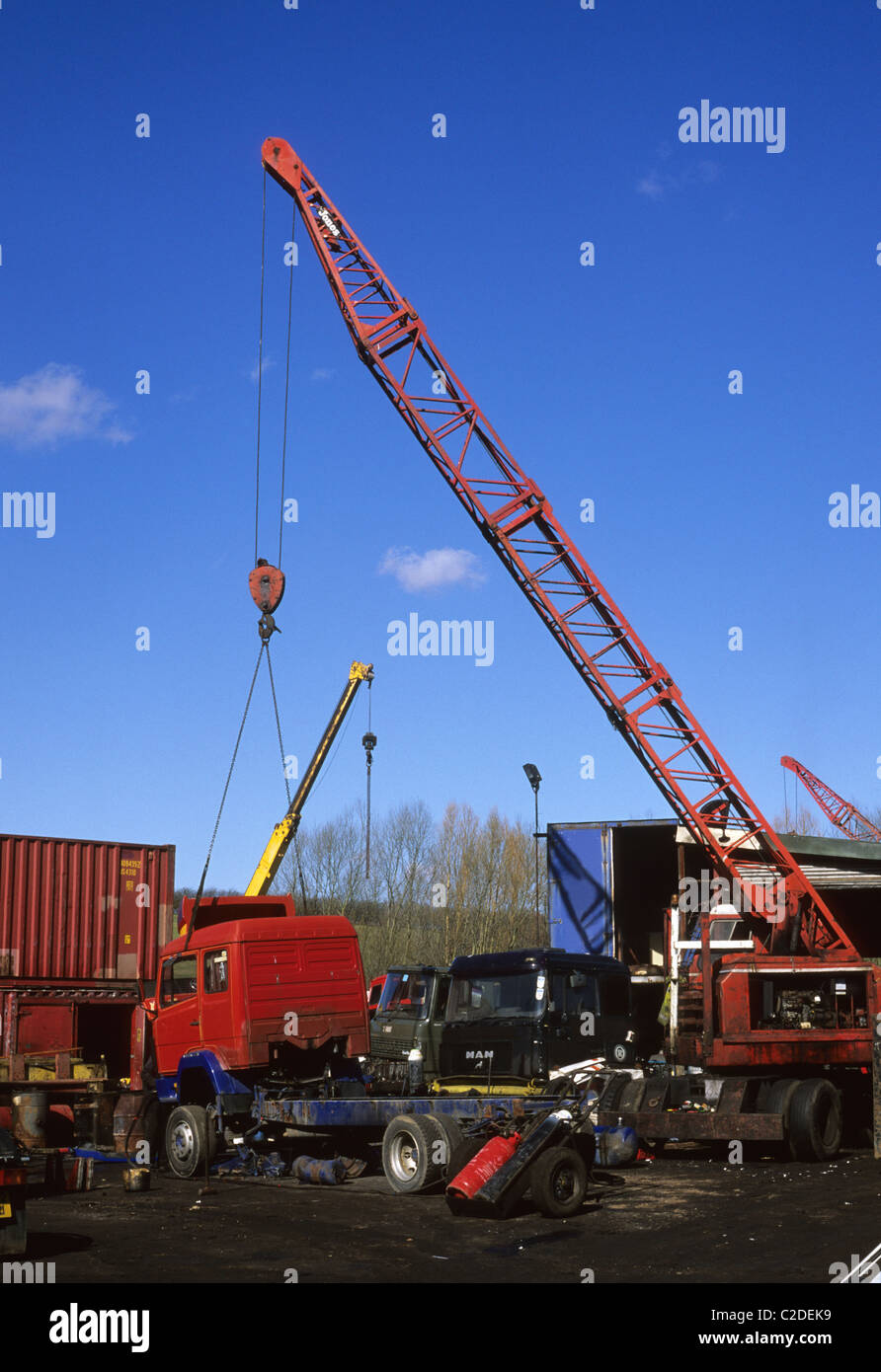 crane lifting lorry cab from chassis at scrapyard uk Stock Photo - Alamy