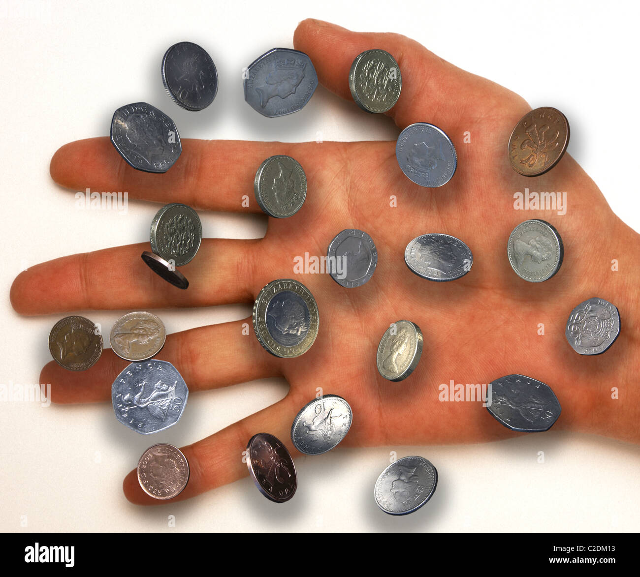 Coins falling into the palm of a mans hand Stock Photo - Alamy