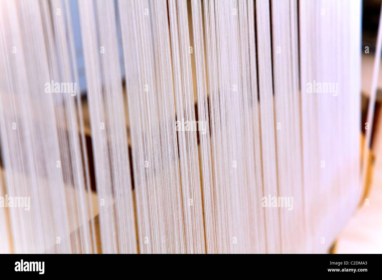 white strings of cloth in a wooden loom Stock Photo - Alamy