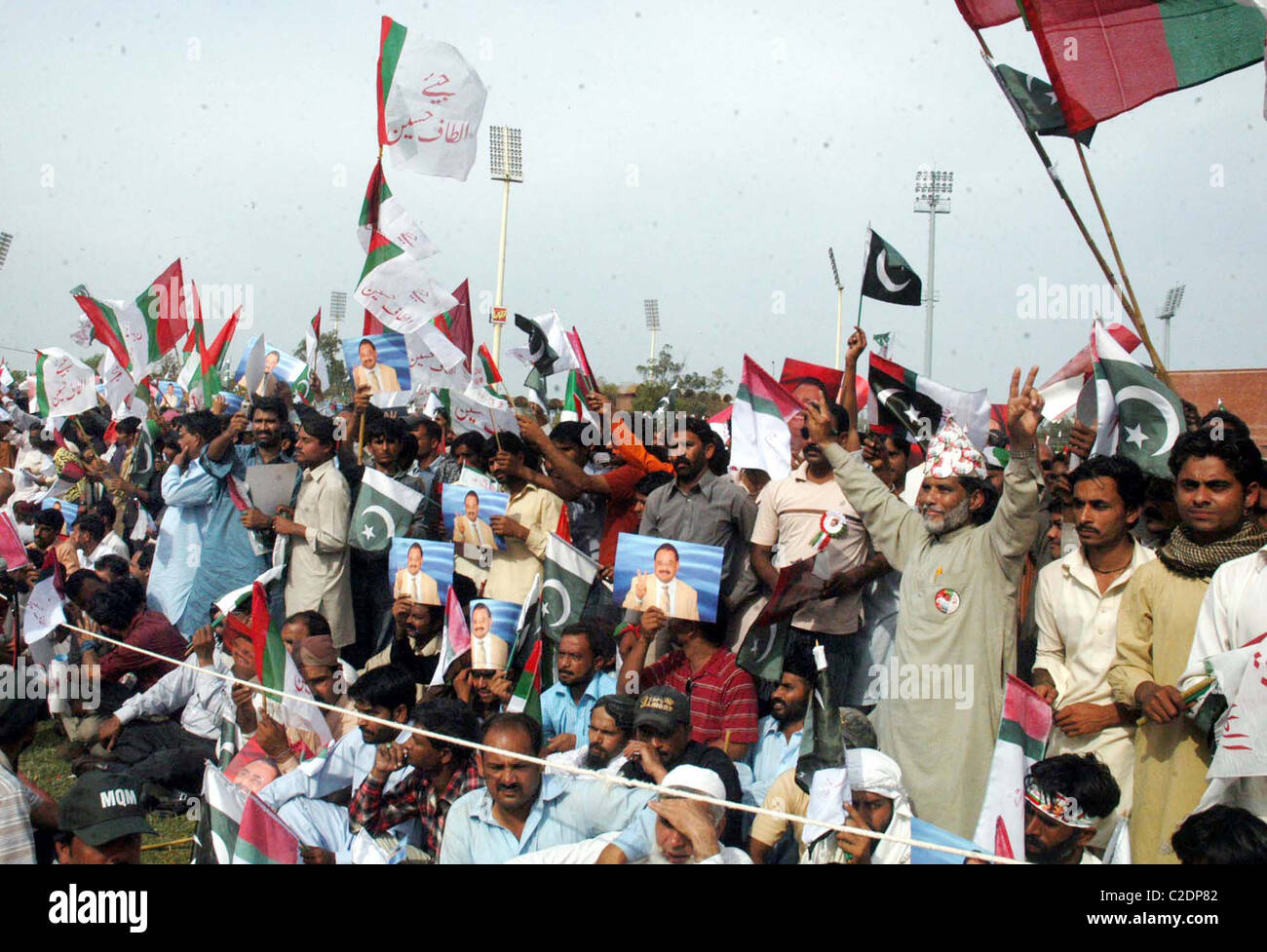 Supporters of Muttehda Qaumi Movement (MQM) hold posters and party ...