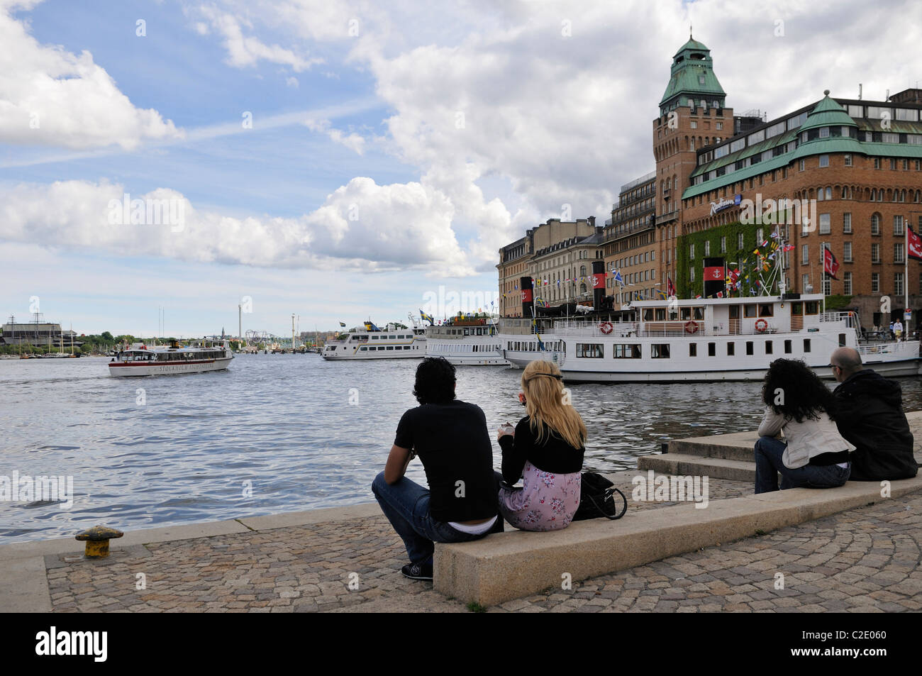 People looking towards ships at the harbor of Stockholm, Stockholms Lan ...
