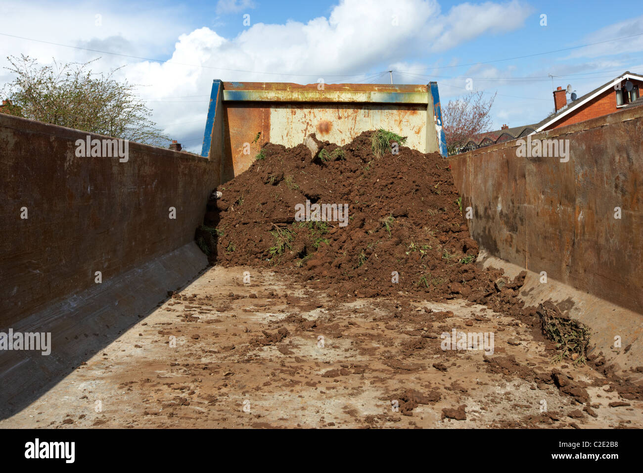 large roll on off building skip containing some soil and garden waste ...