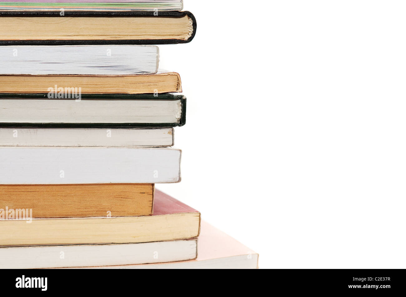 Pile of books, close up image over a white background Stock Photo - Alamy