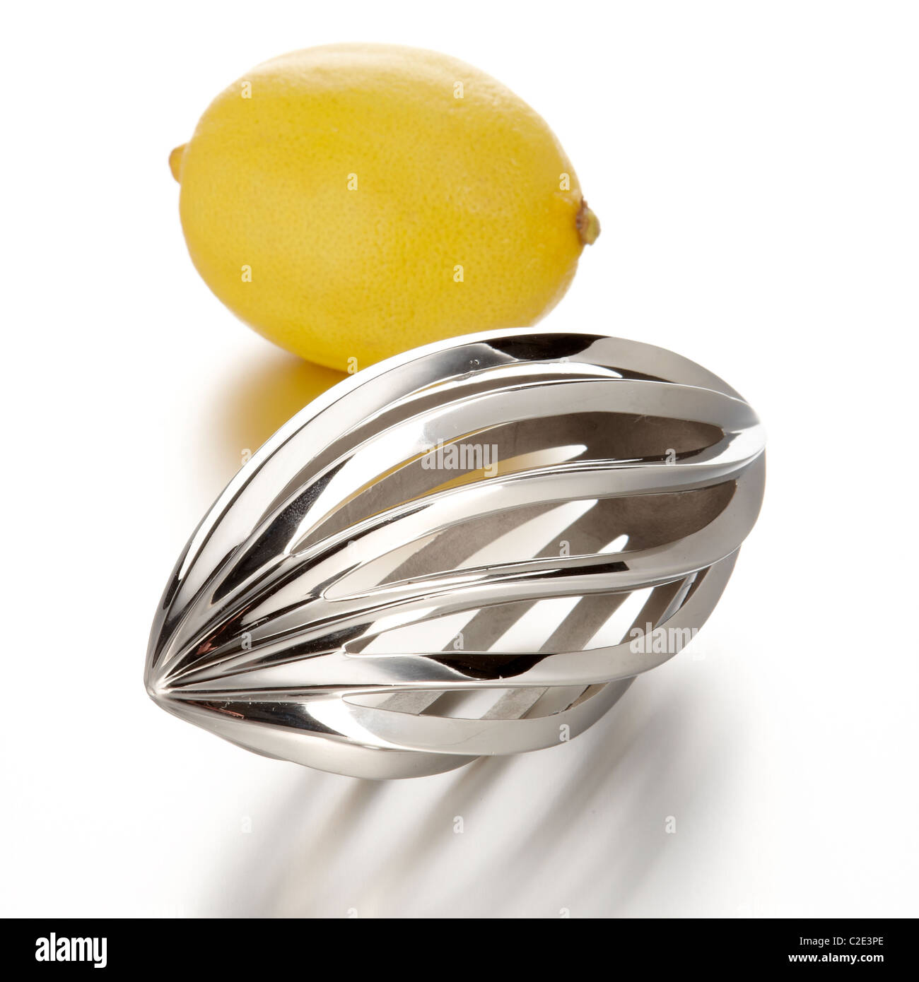 designer lemon squeezer and lemon Stock Photo - Alamy