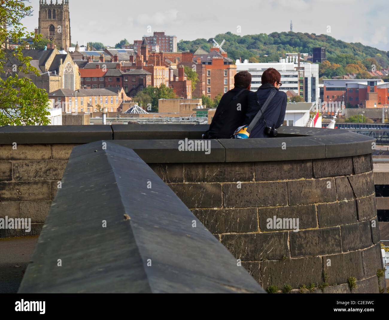Two male tourists admiring the view over the city centre from the walls ...