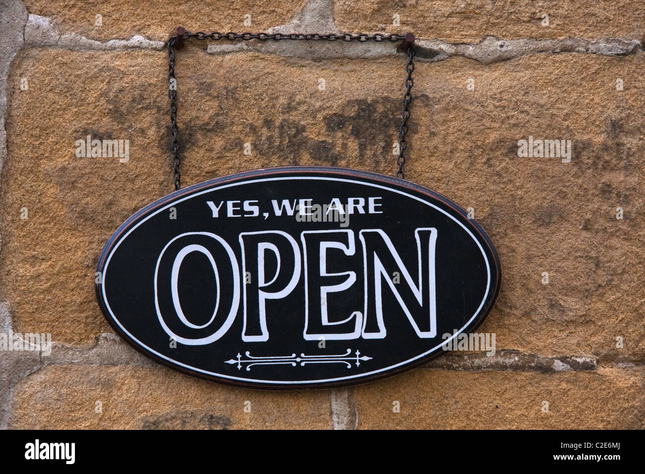 Open sign on wall outside shop, Haworth Stock Photo - Alamy