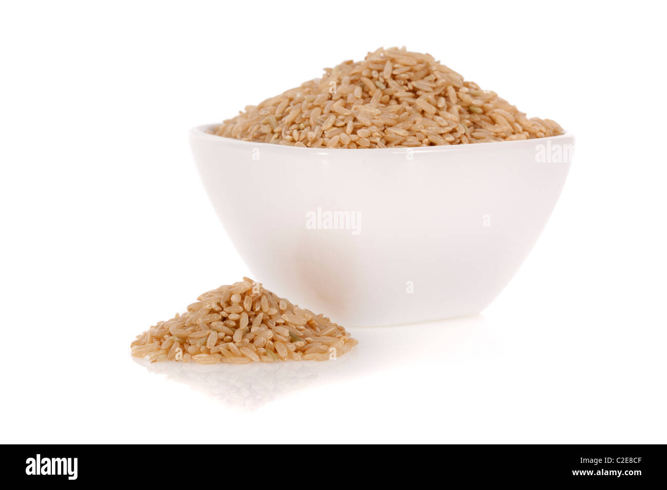 Brown rice in a bowl isolated on a white background Stock Photo - Alamy