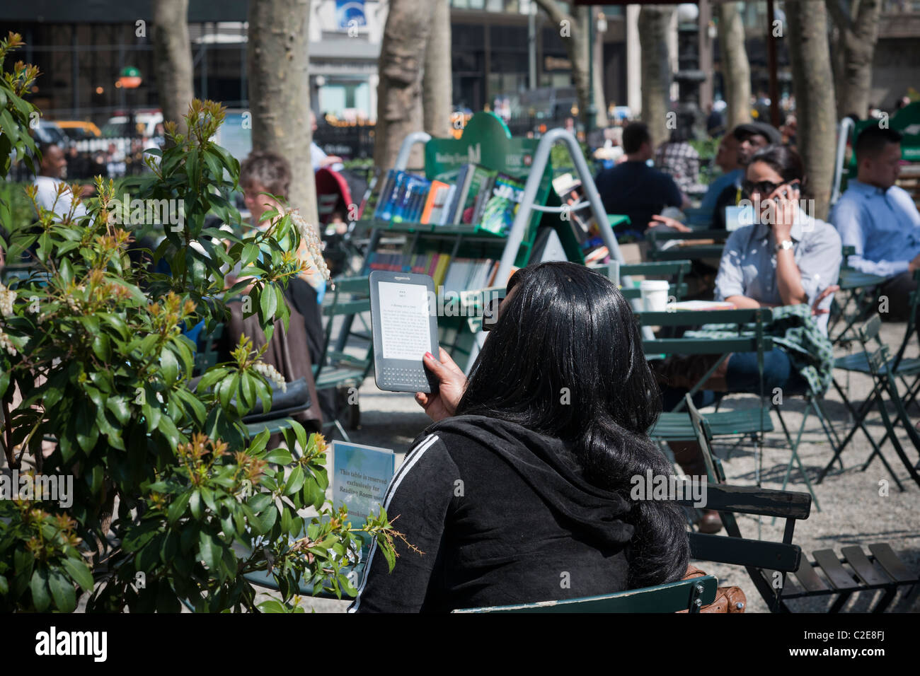 A reader uses her Amazon Kindle electronic book in Bryant Park in New ...