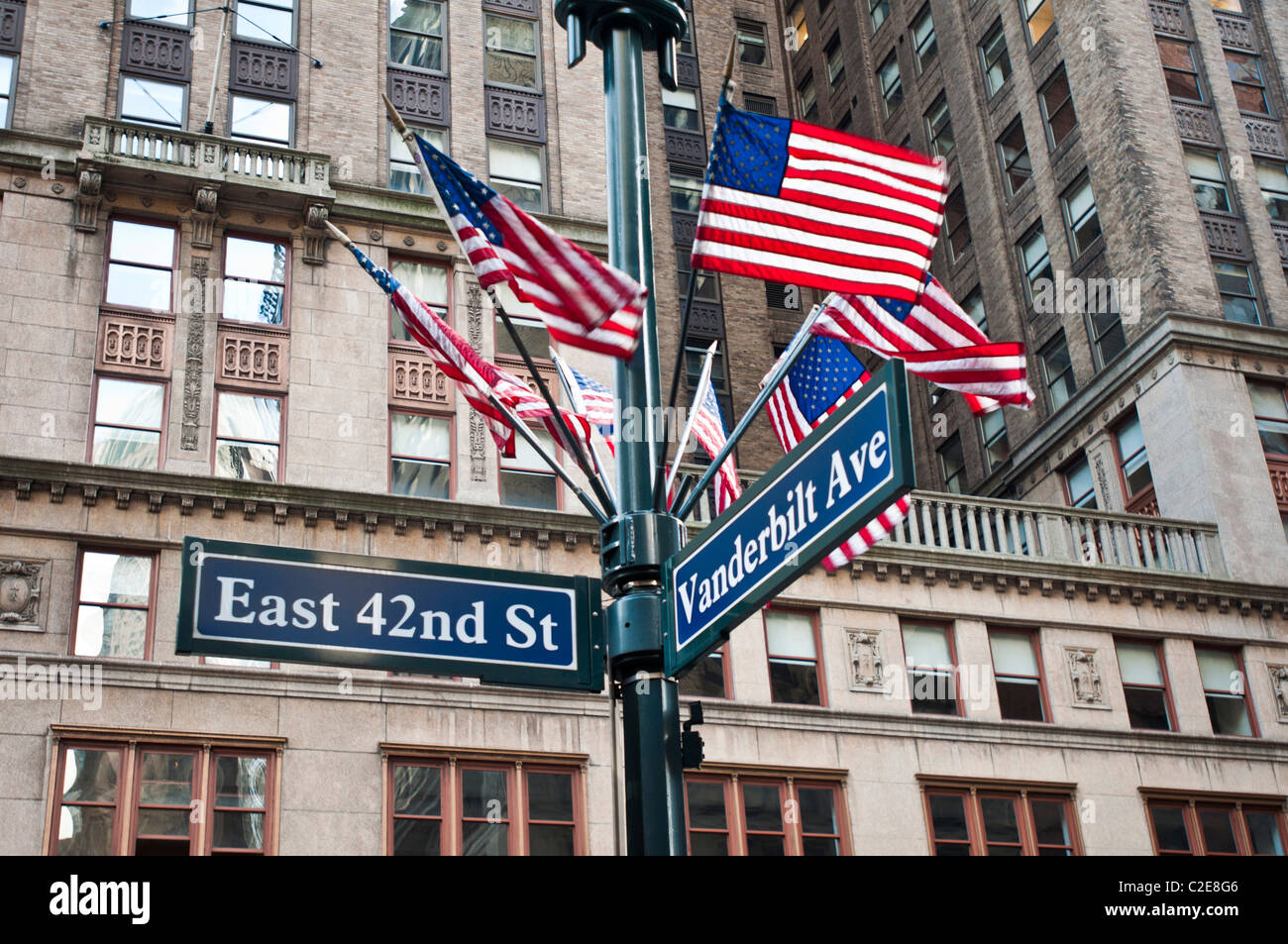 East 42nd Street and Vanderbilt Avenue street sign with American flags ...